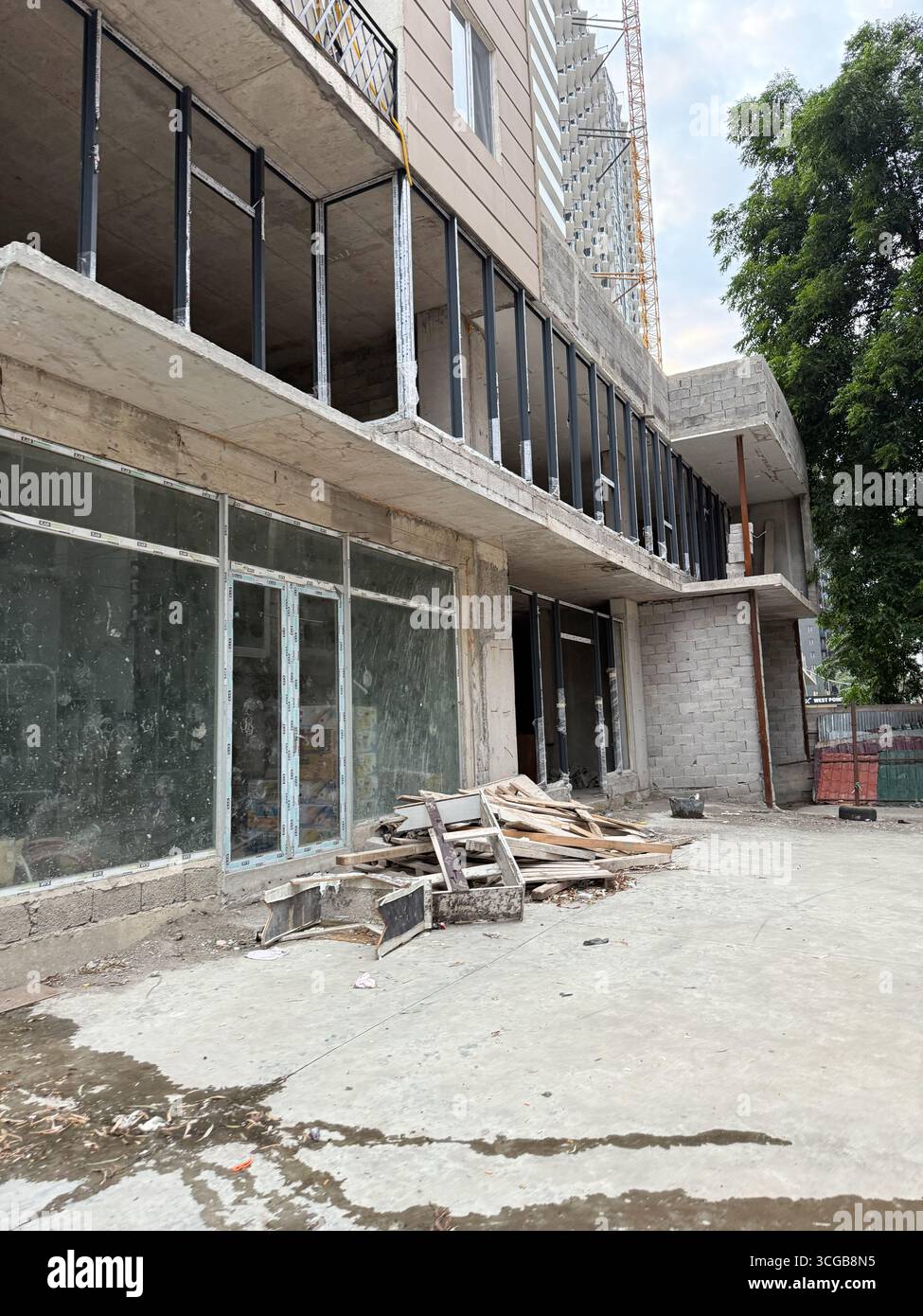 The photo shows a pile of wooden planks, panels, and construction ...