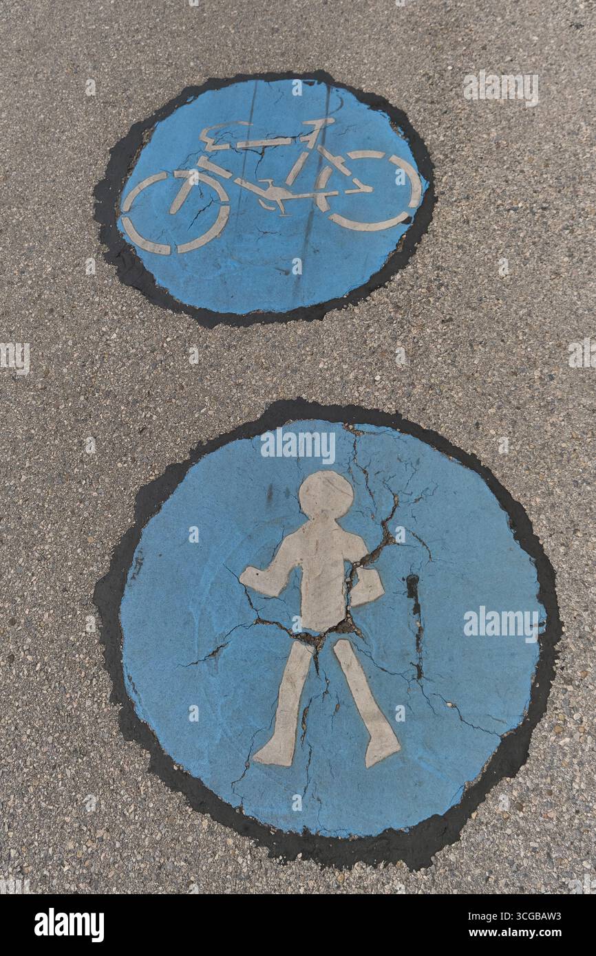 Detailed close-up of asphalt pavement featuring two round blue road ...