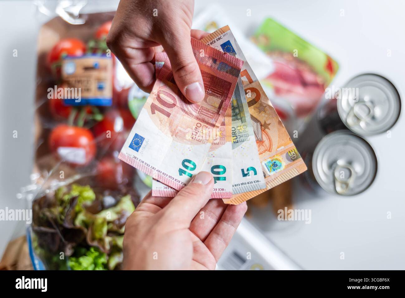 Bavaria, Germany - August 27, 2025: A customer pays for his grocery shopping in the supermarket ...