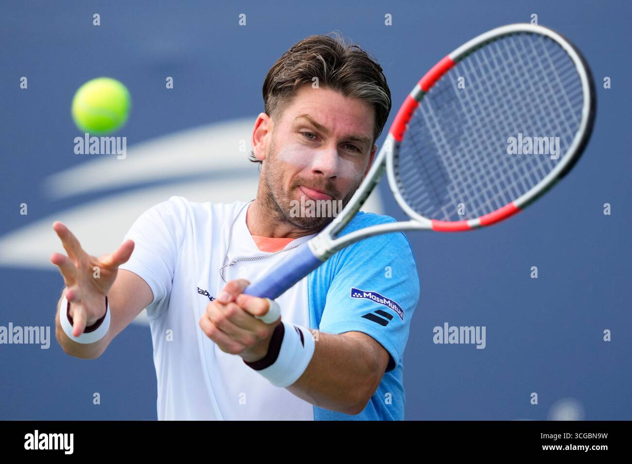 Cameron Norrie, of Great Britain, returns a shot to Francisco Comesana ...