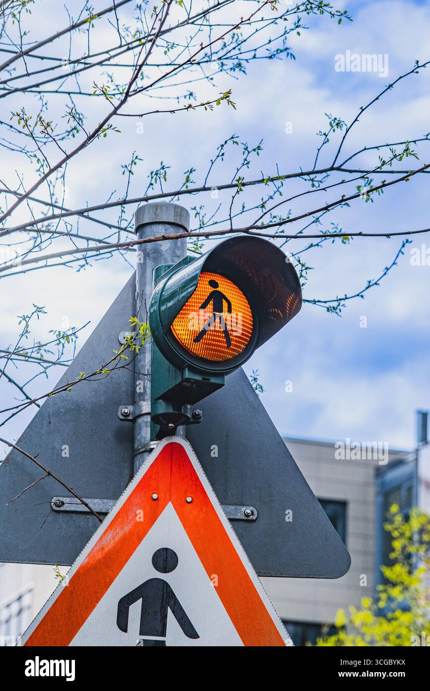 Orange pedestrian warning sign hi-res stock photography and images - Alamy