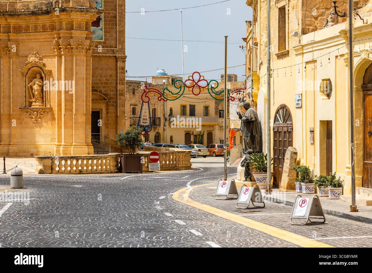 Gozo, Malta – June 23, 2021: Street scene with church facade, statue ...