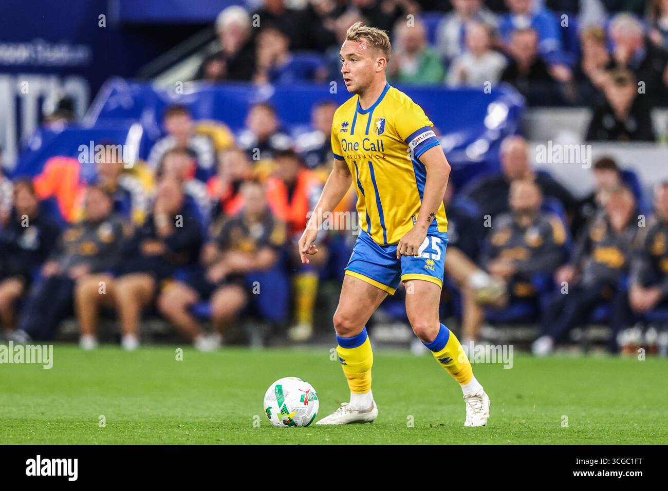 Louis Reed of Mansfield Town holds the ball during the Carabao Cup ...