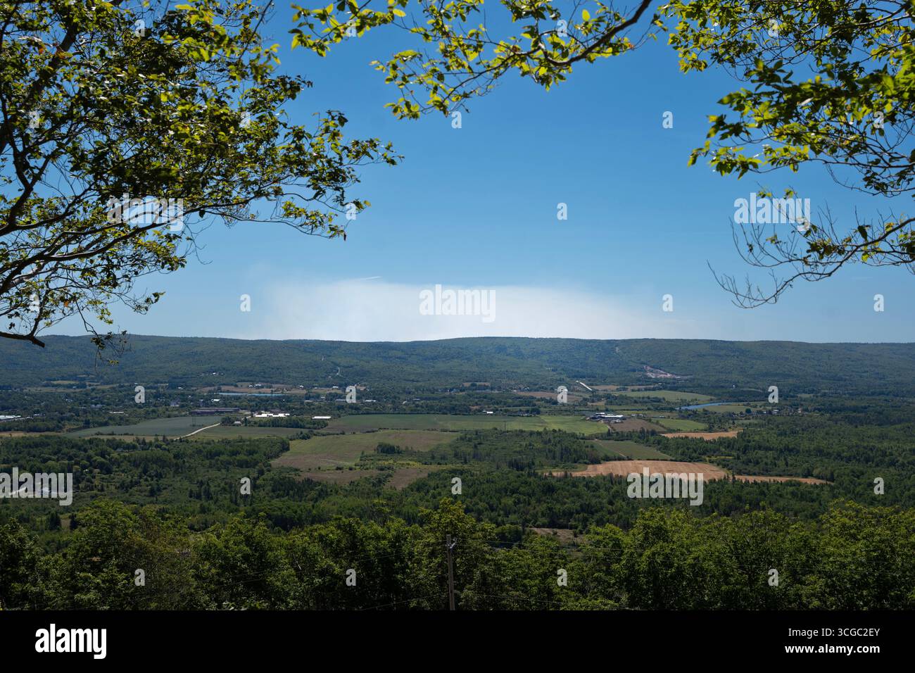 Smoke is seen over the landscape where firefighters are battling the ...