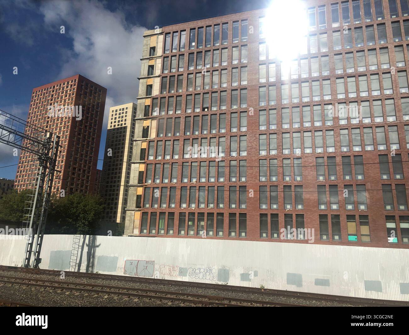 The building from the train window with a reflection on the window is a ...