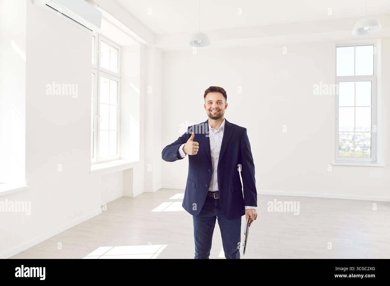 Happy Real Estate Agent Giving Thumbs Up In New Home Or Office Stock ...
