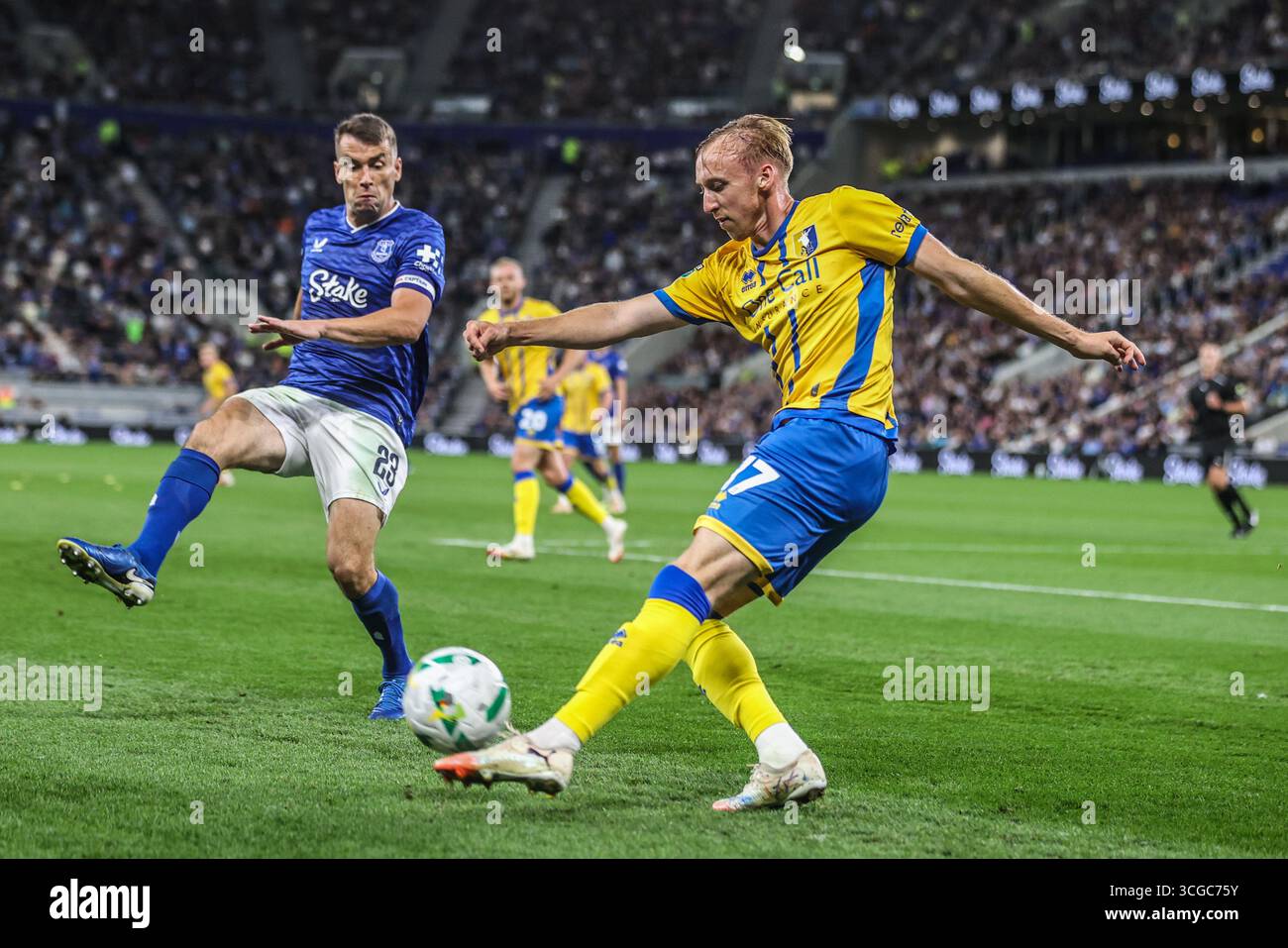 Max Dickov of Mansfield Town clears the ball under pressure from Séamus Coleman of Everton ...
