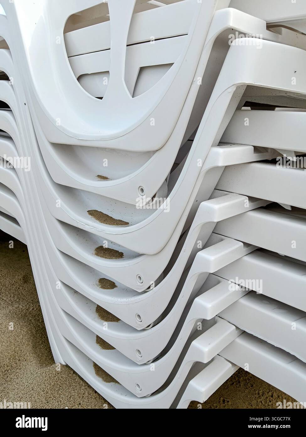 Neatly stacked plastic chairs hi-res stock photography and images - Alamy