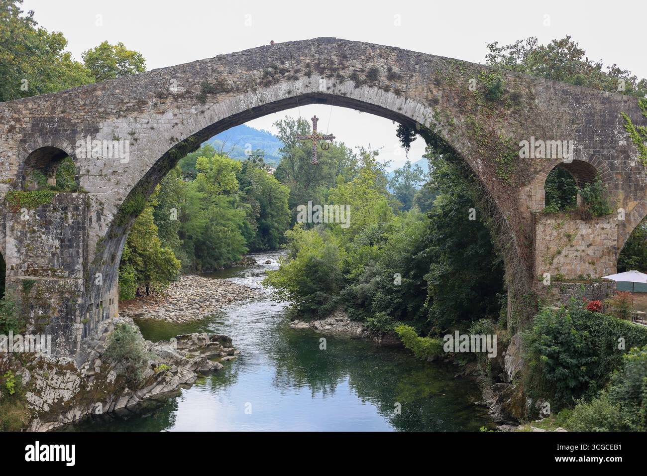 Cangas de Onís, Spain, August 27, 2025: View of the medieval bridge of ...