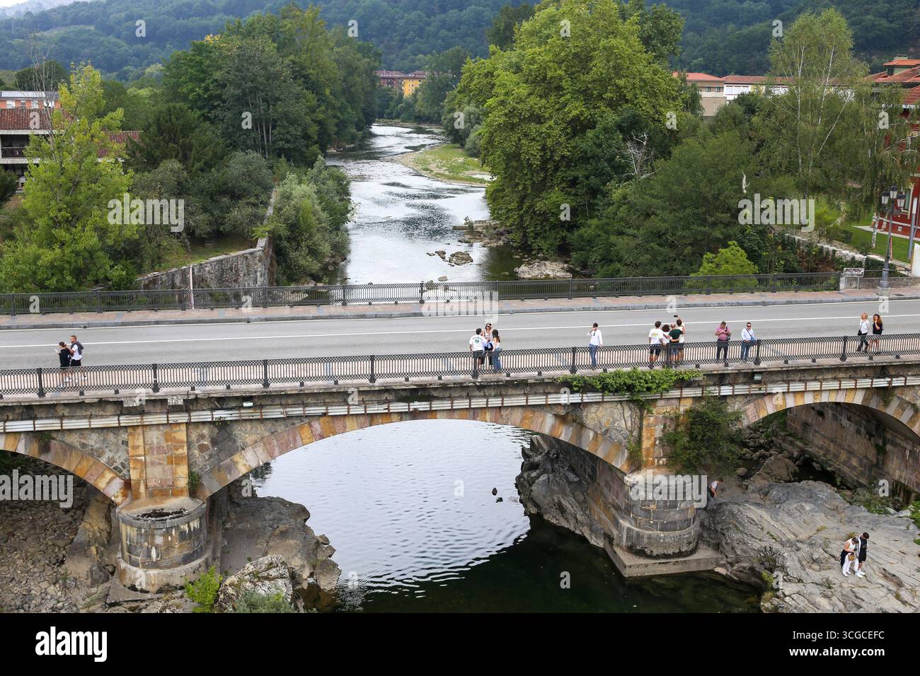 Cangas de Onís, Spain, August 27, 2025: Tourists taking photos with the ...