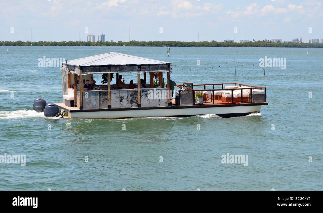 A barge converted into a floating cocktail lounge cruising on Biscayne ...