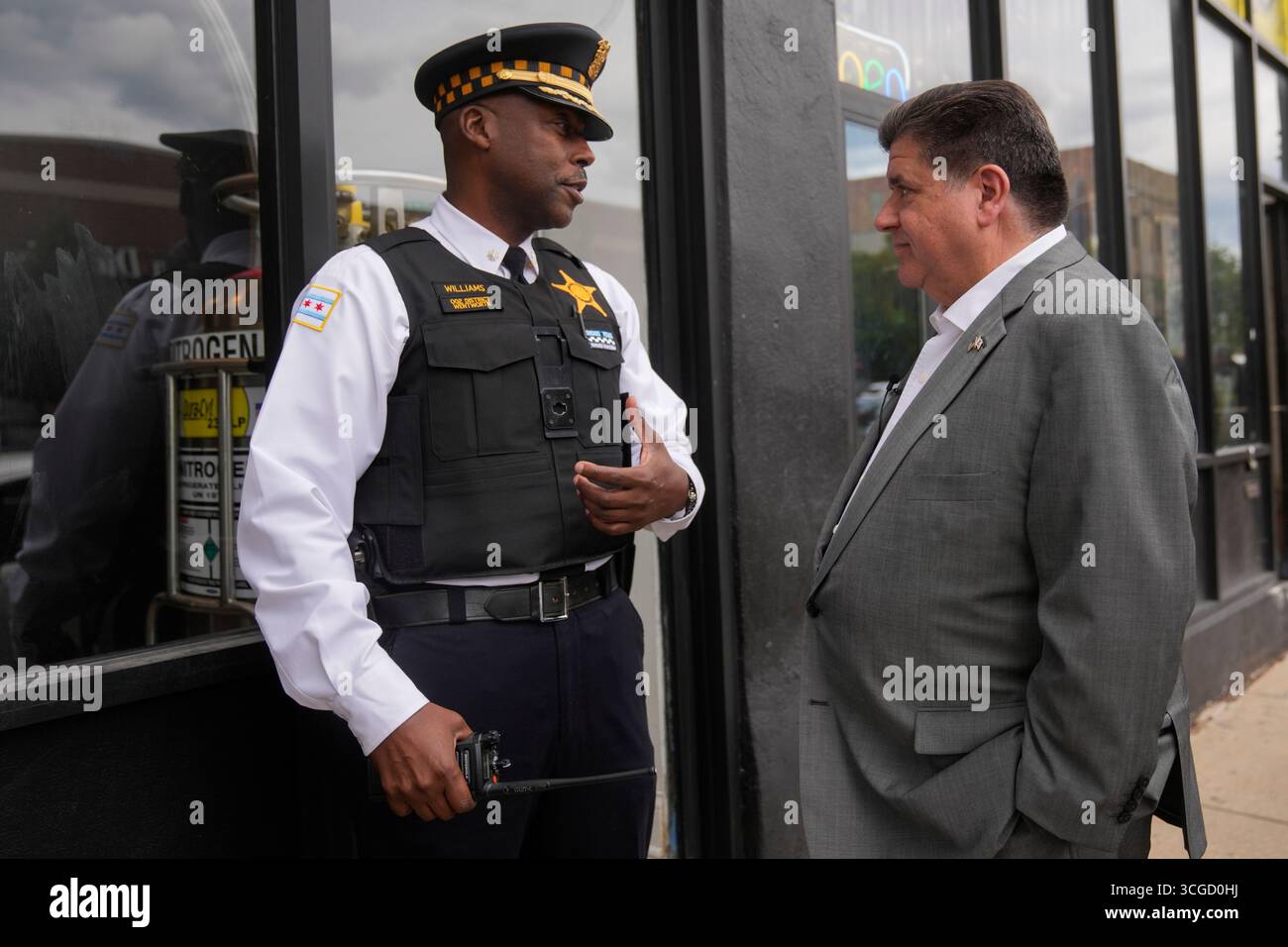 Chicago Police Cmdr, Herbert Williams, left, speaks with Illinois Gov ...