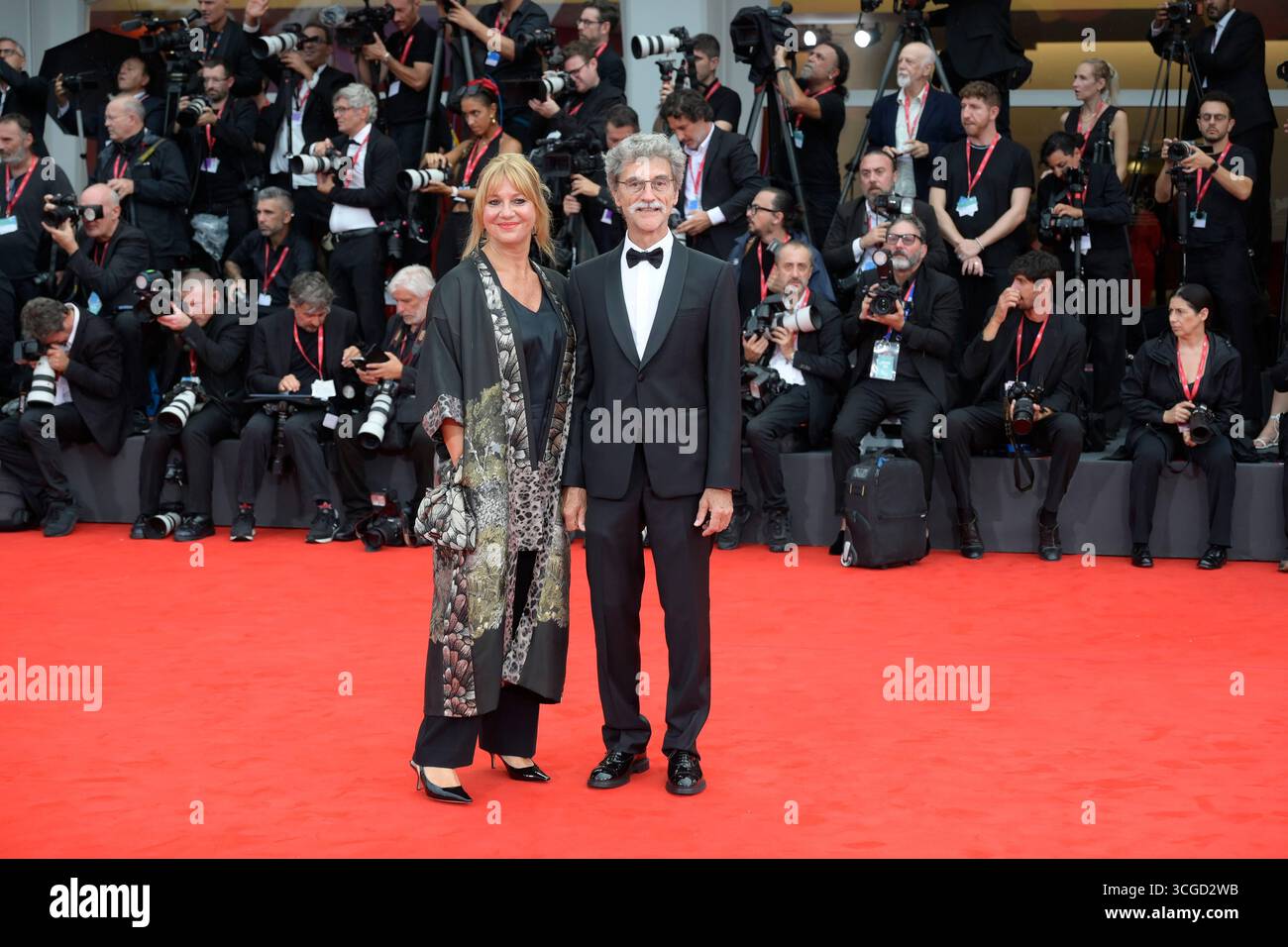 Venice Lido, Italy. 27th Aug, 2025. Silvio Soldini (r) and wife (l ...