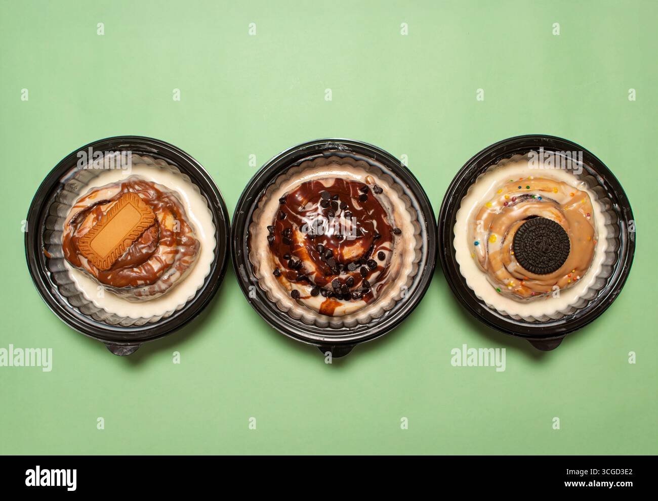 Top down flat lay of three different gourmet cinnamon buns in a row ...