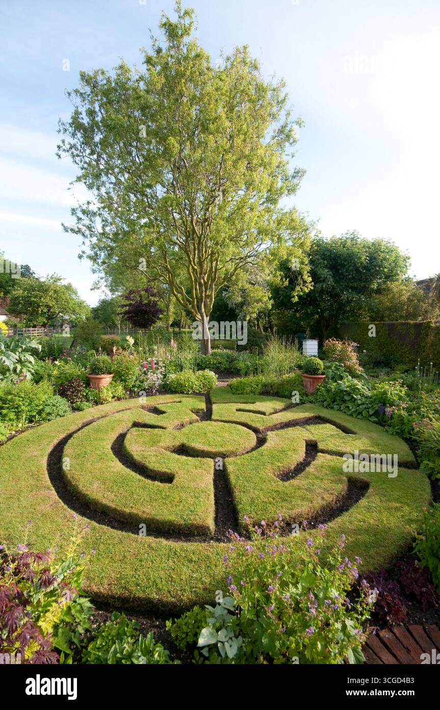 An elaborate garden layout showcases a circular pattern of trimmed ...