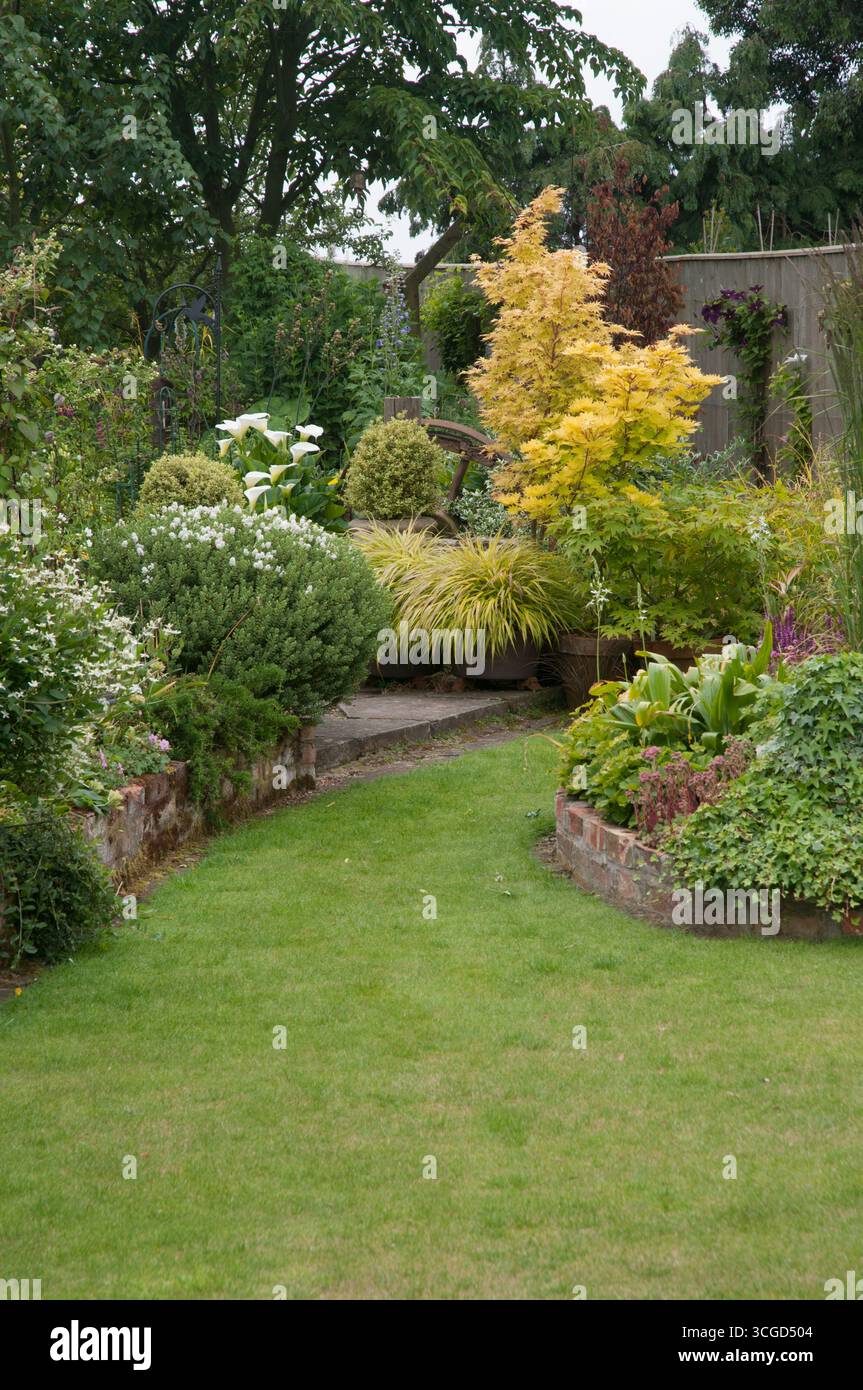 A winding pathway meanders through a vibrant garden filled with diverse ...