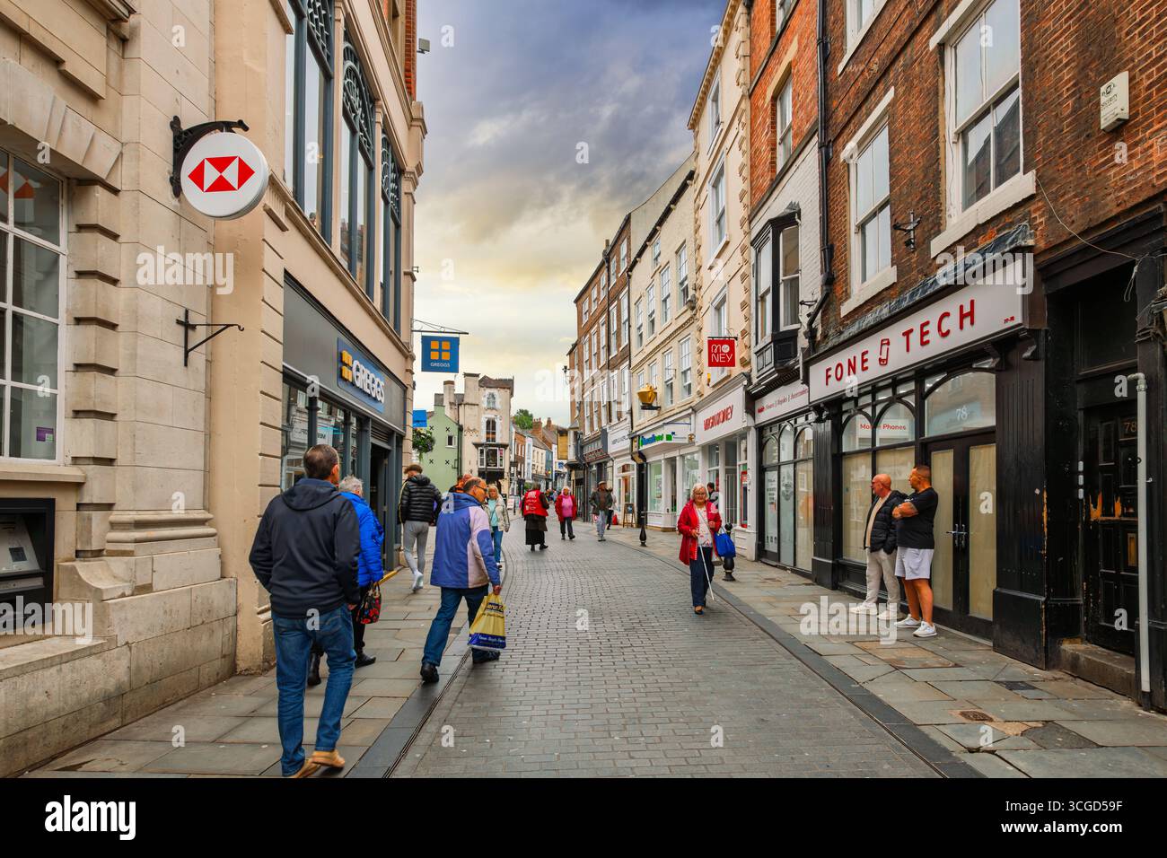 The historic hillside Saddler Street, full of shops, pubs and cafes, in ...
