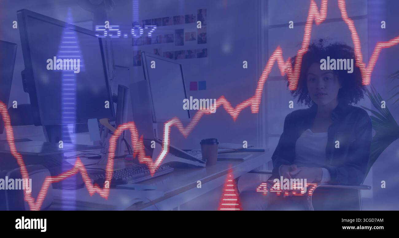 Woman in business casual monitoring stock graphs in open office, with ...