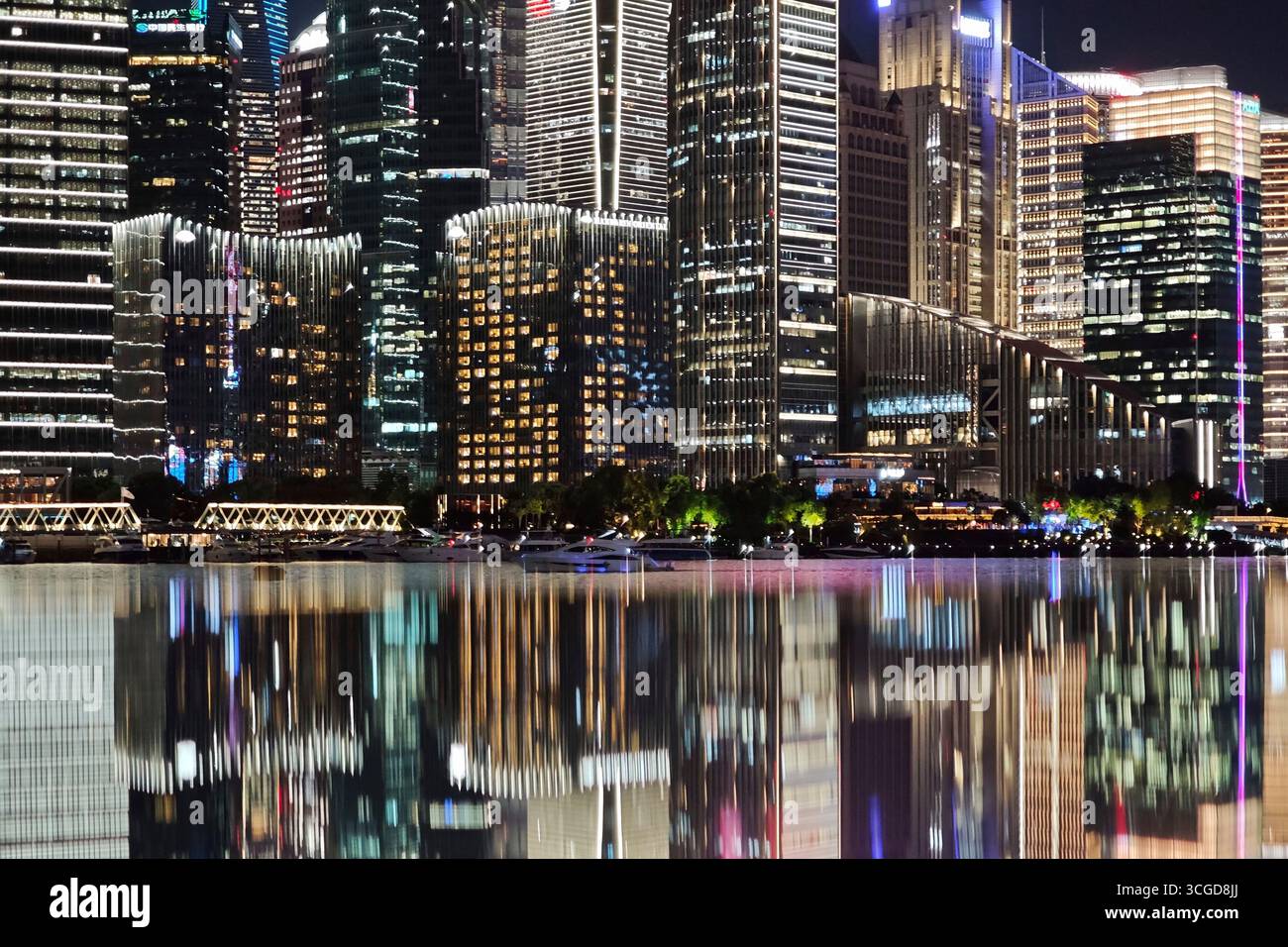 A night view of illuminated high-rise buildings in Lujiazui and their ...