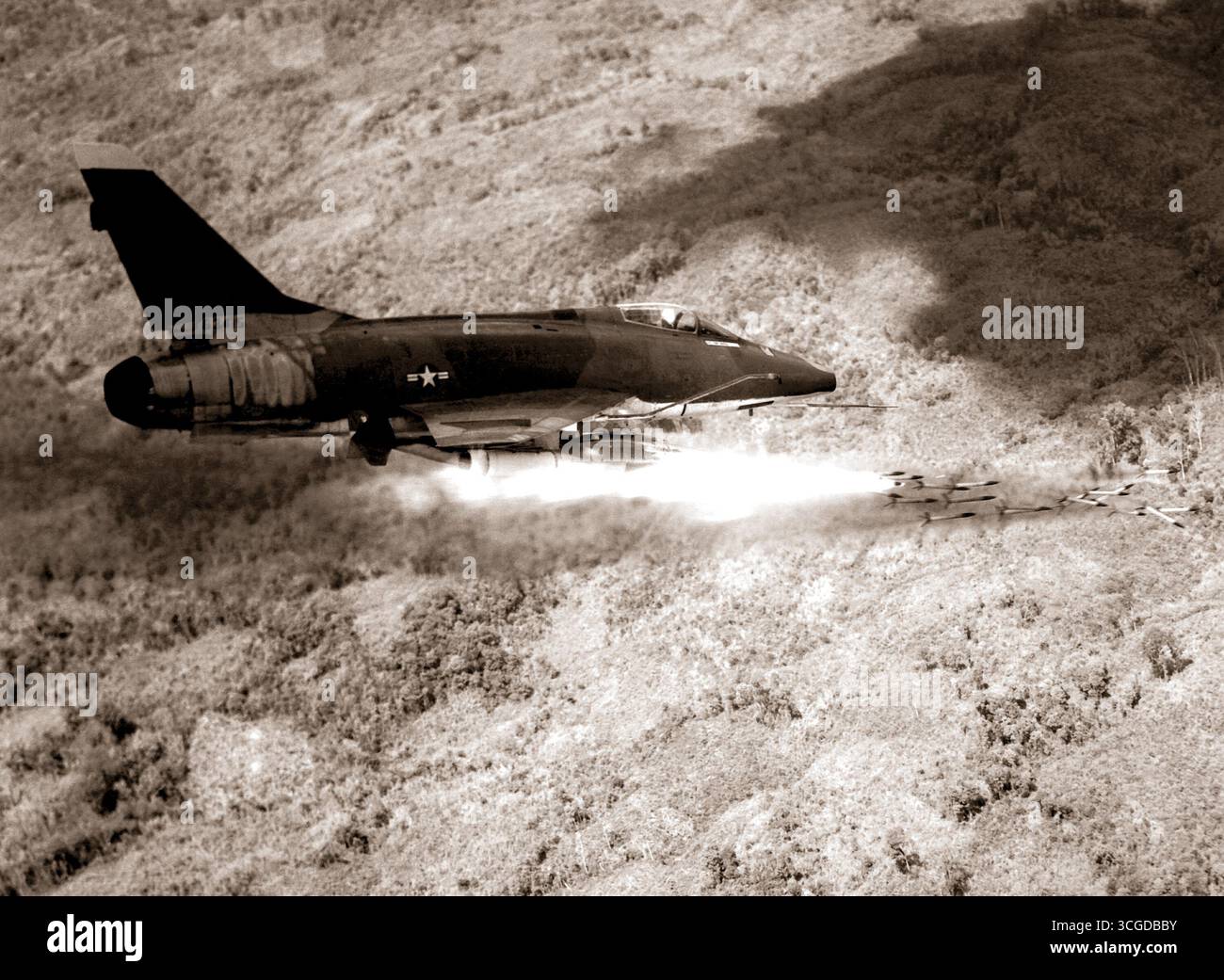 An Air Force F-100D Super Sabre aircraft fires a salvo of 2.75-inch ...
