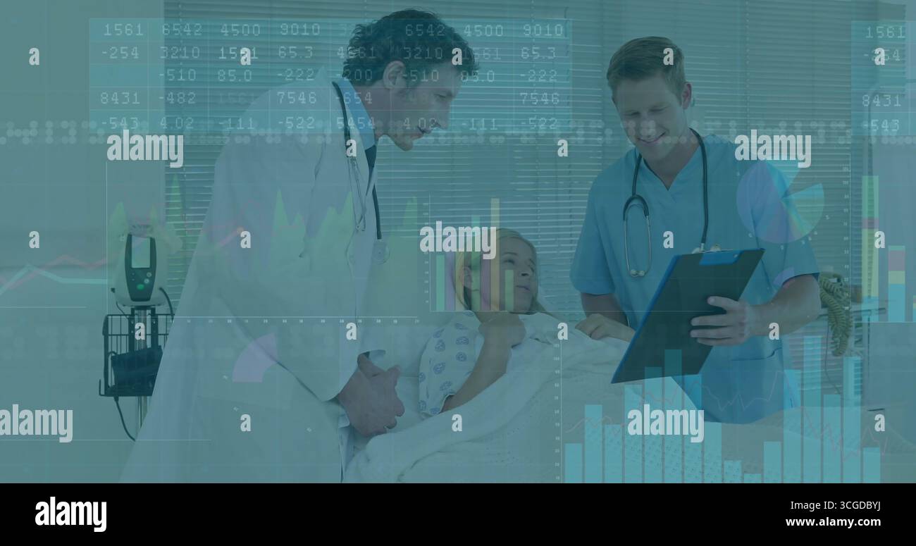 Reviewing patient vitals doctor and nurse leaning over hospital bed ...