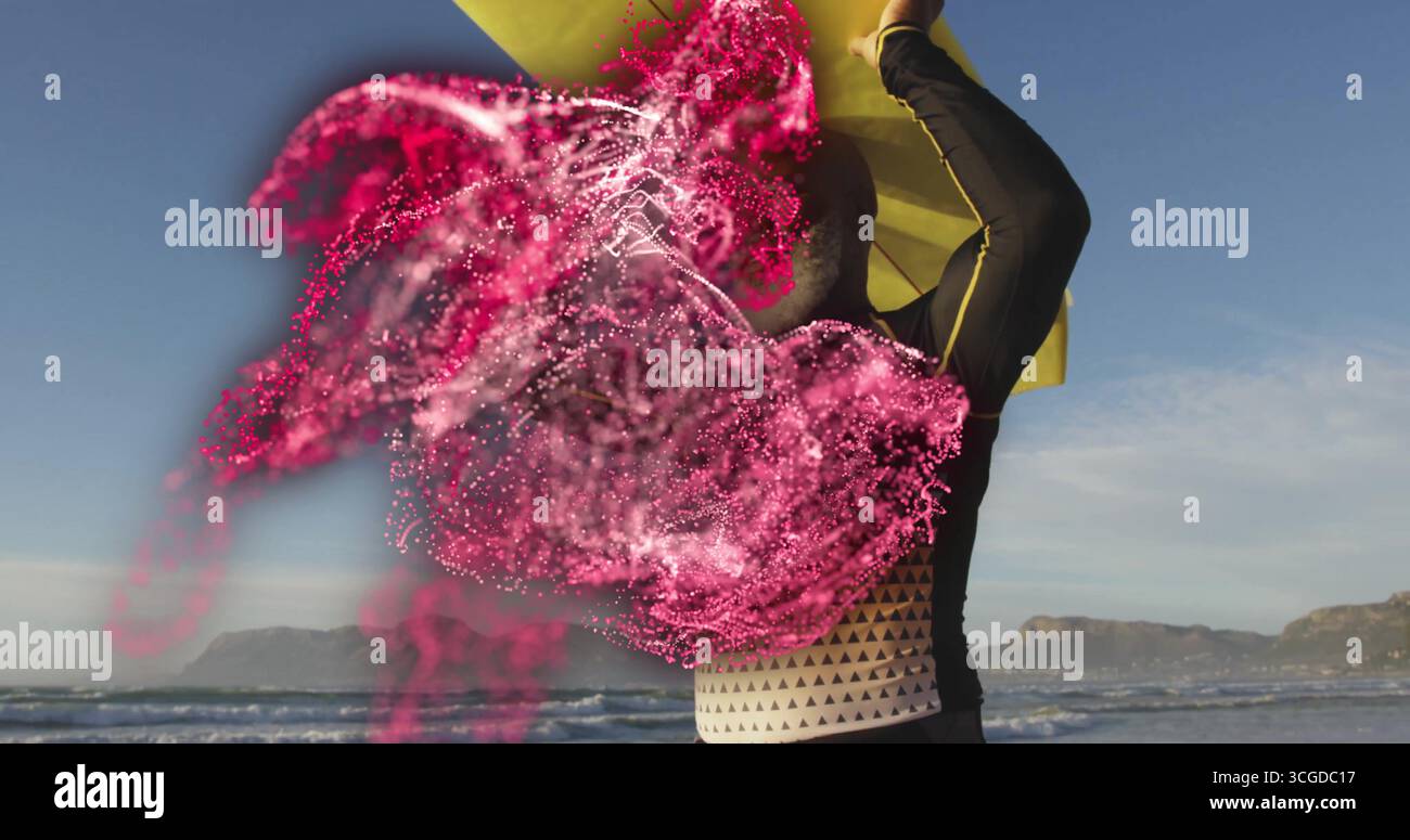 Throwing athletic woman tossing bright magenta powder on sandy beach ...