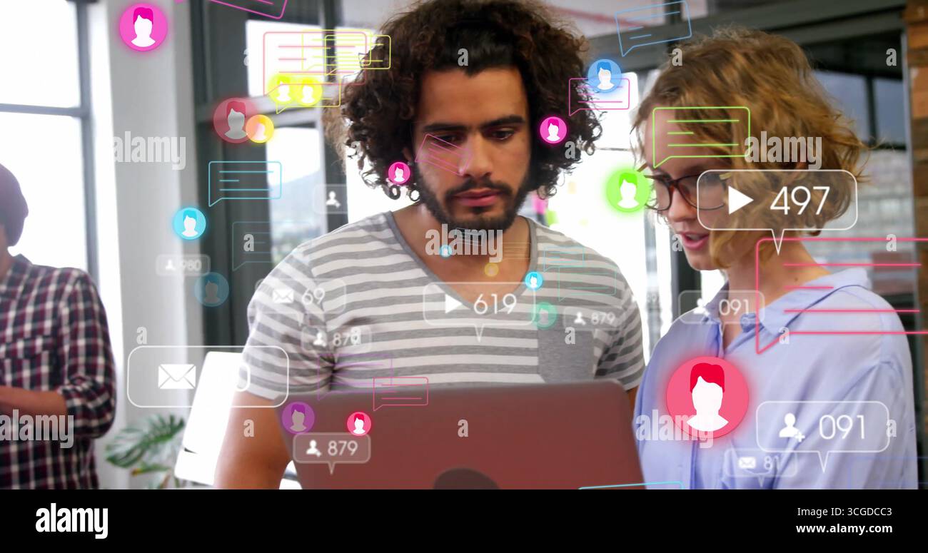 Two coworkers reviewing laptop screen in modern office, with floating ...