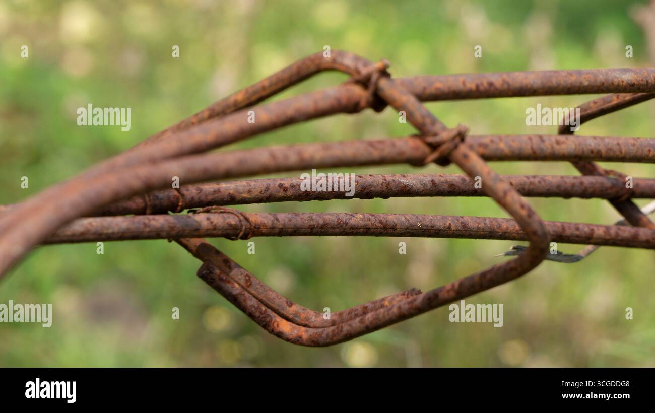 Close-up of severely rusted metal bars forming an aged framework ...