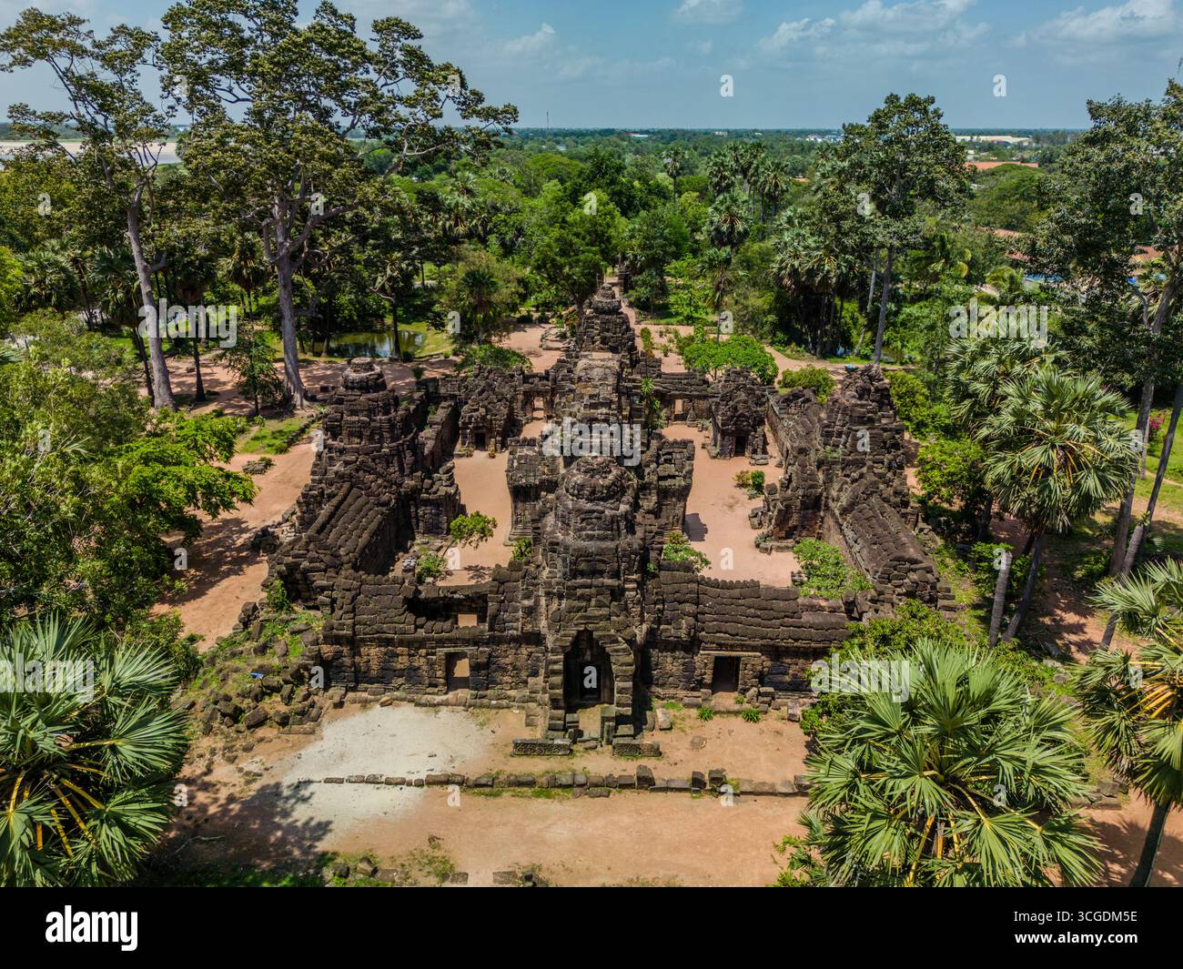 Aerial view of the ancient Ta Prohm Temple surrounded by lush greenery ...