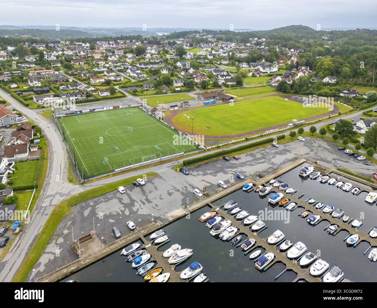 Aerial view of boats nestled in the harbor contrasting with the green ...