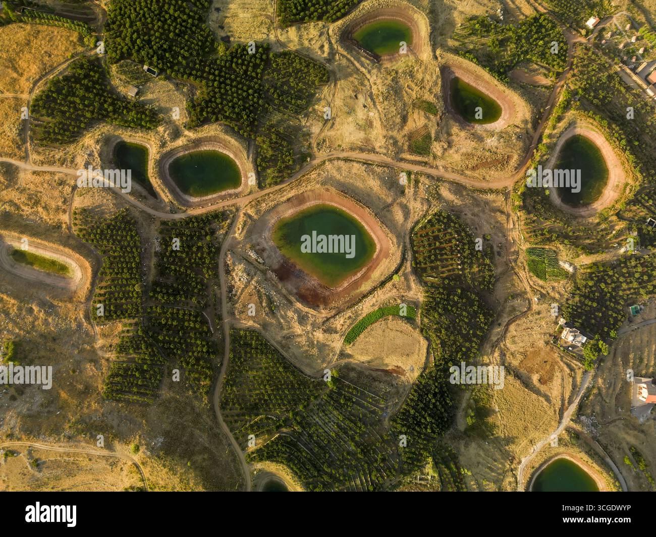 Aerial view of the serene ponds scattered across the rugged terrain ...