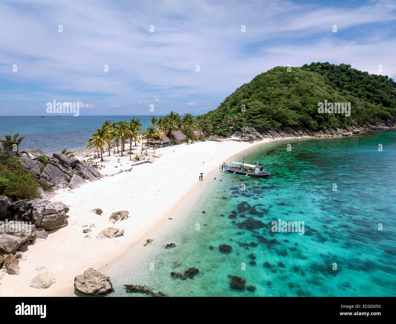 Aerial view of a pristine white beach meeting the turquoise sea ...