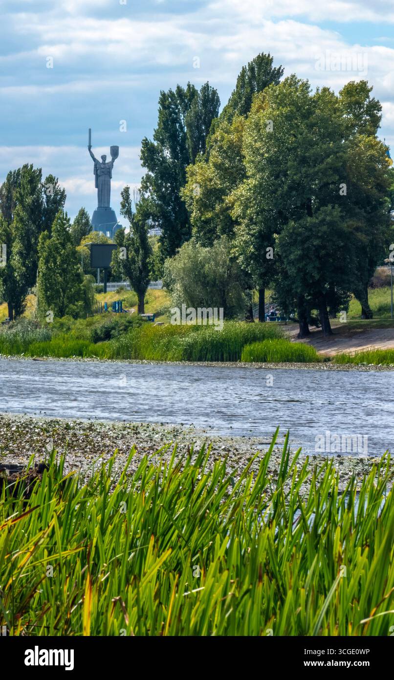 Lush green vegetation thrives along the riverbank, with the iconic ...