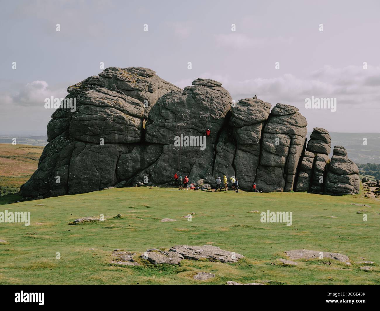 Rock face climbers practising at Haytor Rocks on Dartmoor Devon England ...