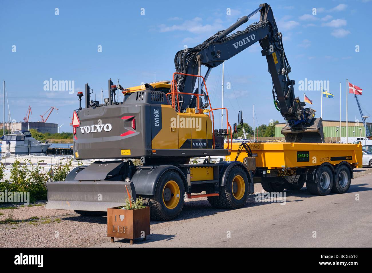 Landskrona, Sweden ; August 8, 2025: Volvo wheeled excavator with dump ...