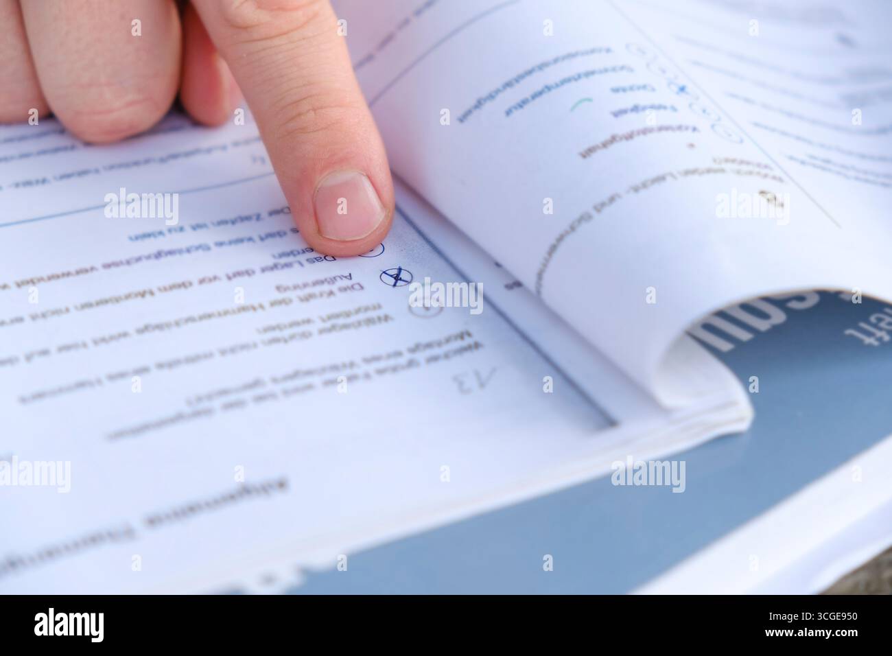 Close-up of fingers flipping through workbook pages during study. Hand ...