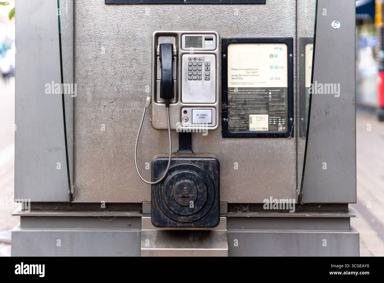 Old style BT public pay telephone phone booth on a high street in ...