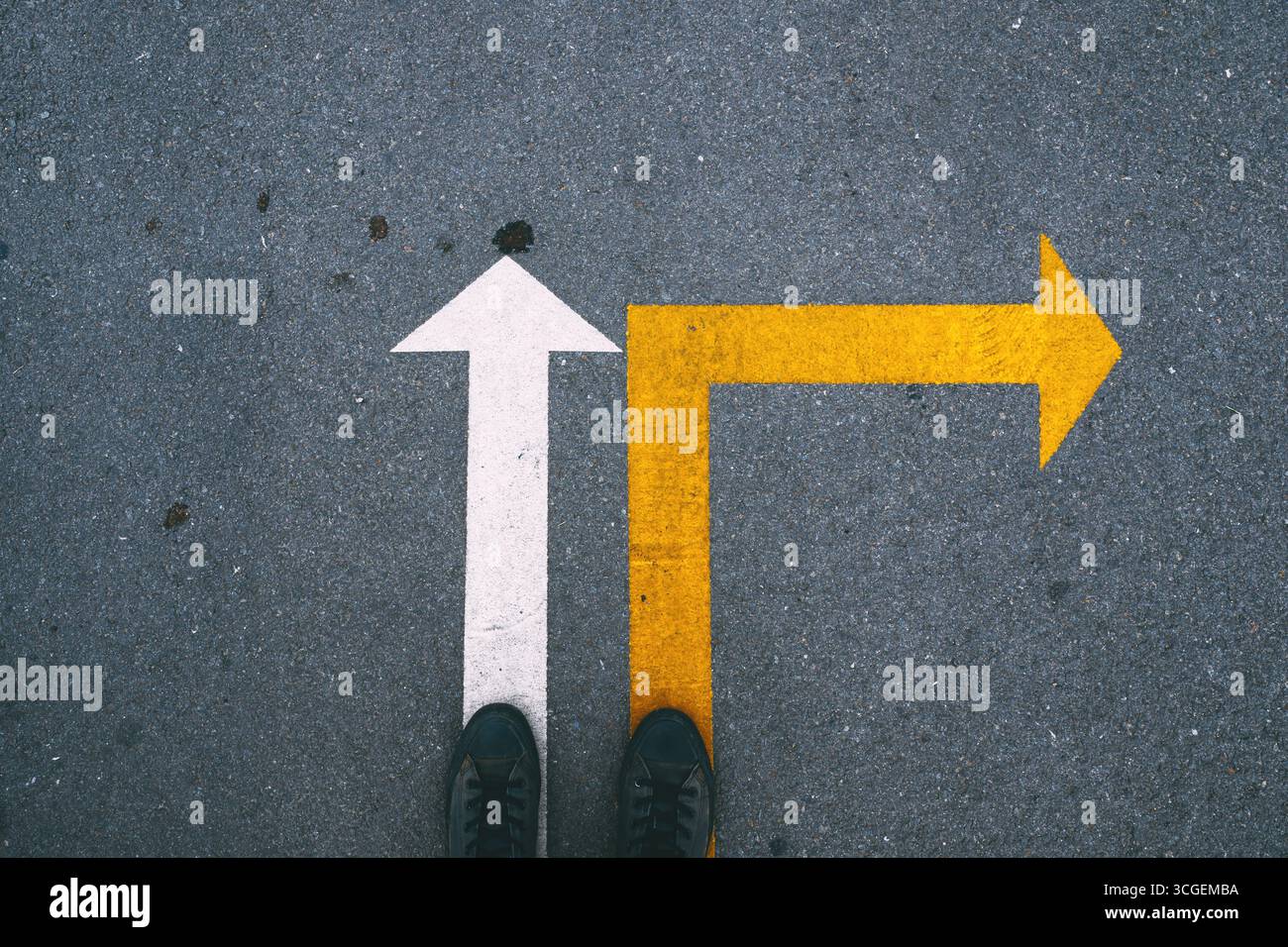 White and yellow arrows on asphalt showing different directions ...