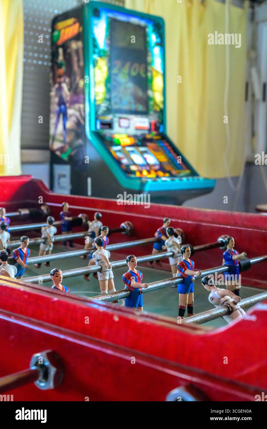 Groups of friends play spirited foosball at a village bar in Puebla del ...