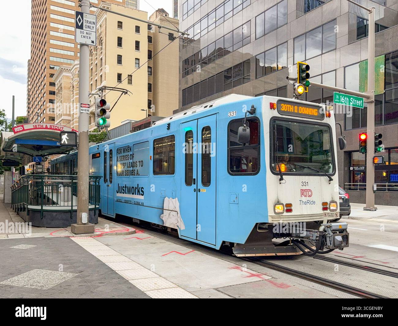 Denver, Colorado, USA - 4 June 2025: Electric tram leaving a station on ...
