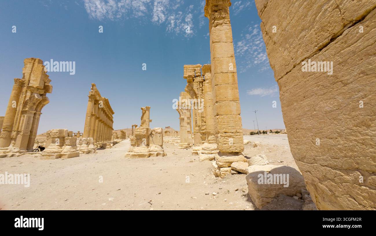 Ancient stone ruins under a clear blue sky, showcasing tall columns and ...