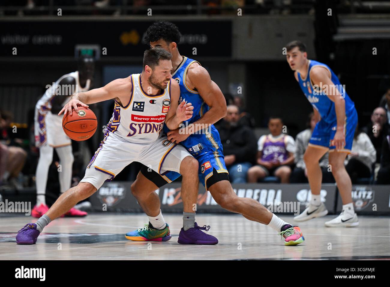 Matthew Dellavedova of the Sydney Kings fights for the ball with Sam ...