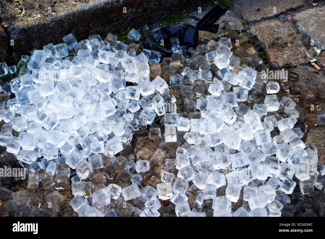 Cubes of ice dumped on the cobbled street melting in Copenhagen ...