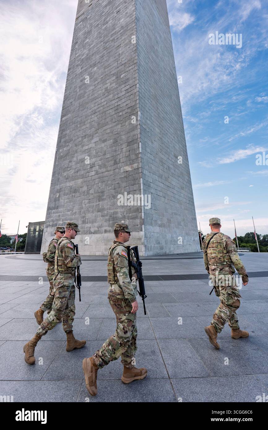 National Guard troops patrol the grounds of the Washington Monument as ...