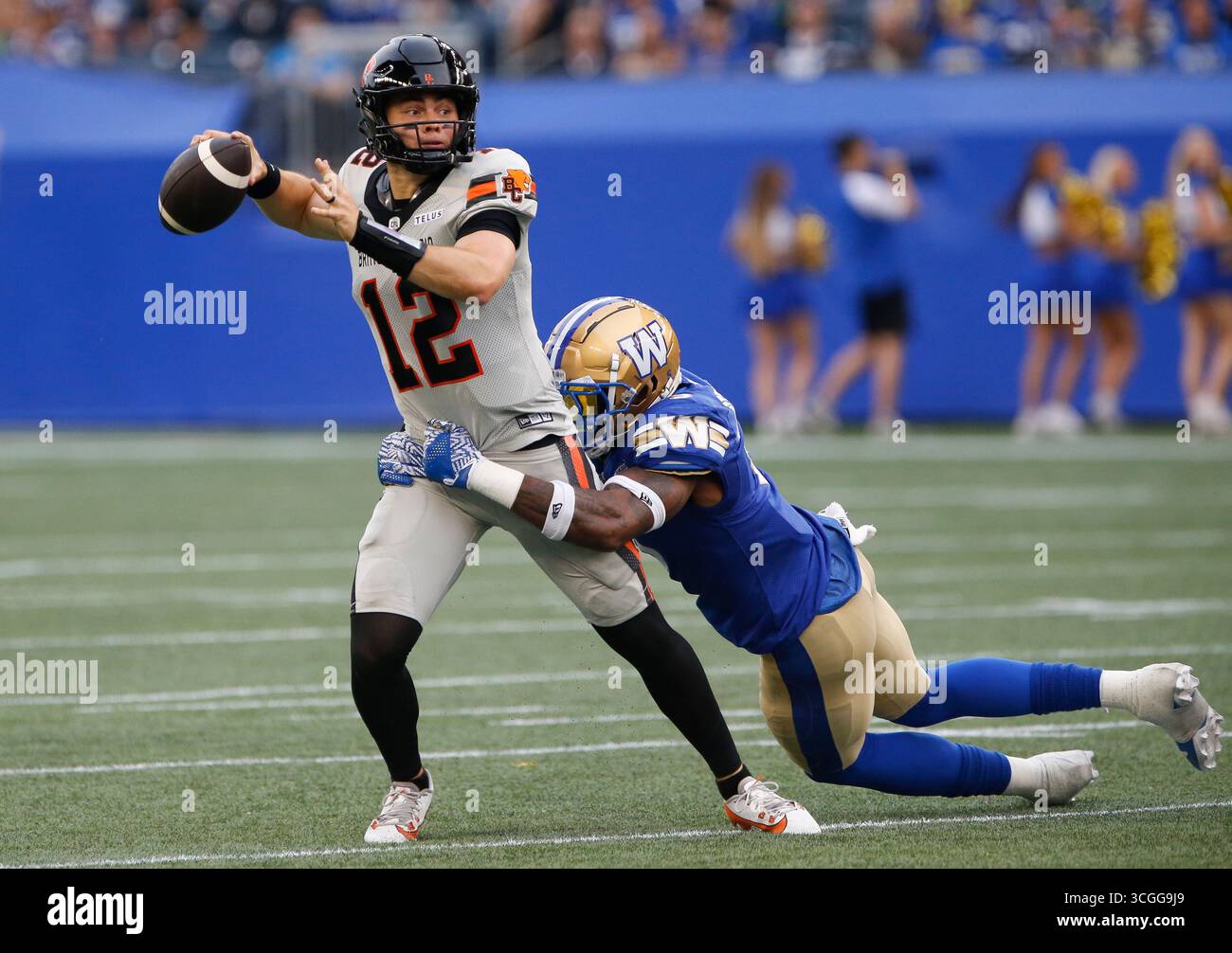 BC Lions quarterback Nathan Rourke (12) gets wrapped up by Winnipeg Blue Bombers' Willie ...