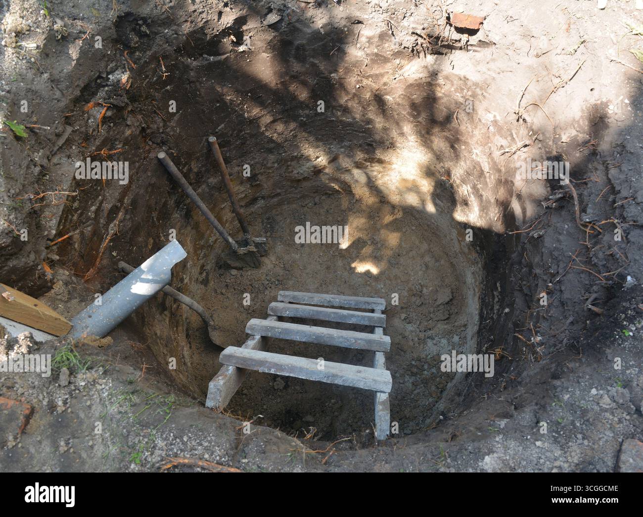 A round empty pit dug in the ground for a toilet septic tank Stock ...