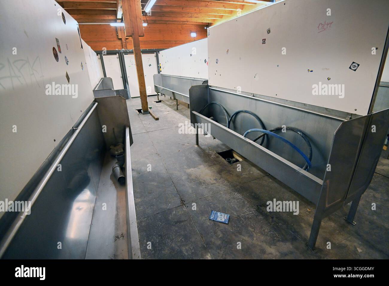 Toilets in the tents before installation: urinals, metal troughs, metal ...