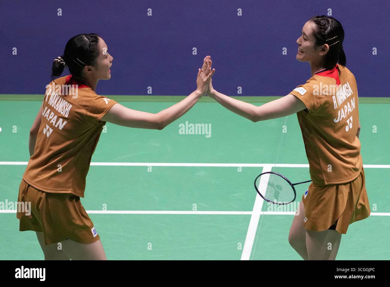 Japan's Rin Iwanaga, right, and Kie Nakanishi play China's Li Yi Jing ...