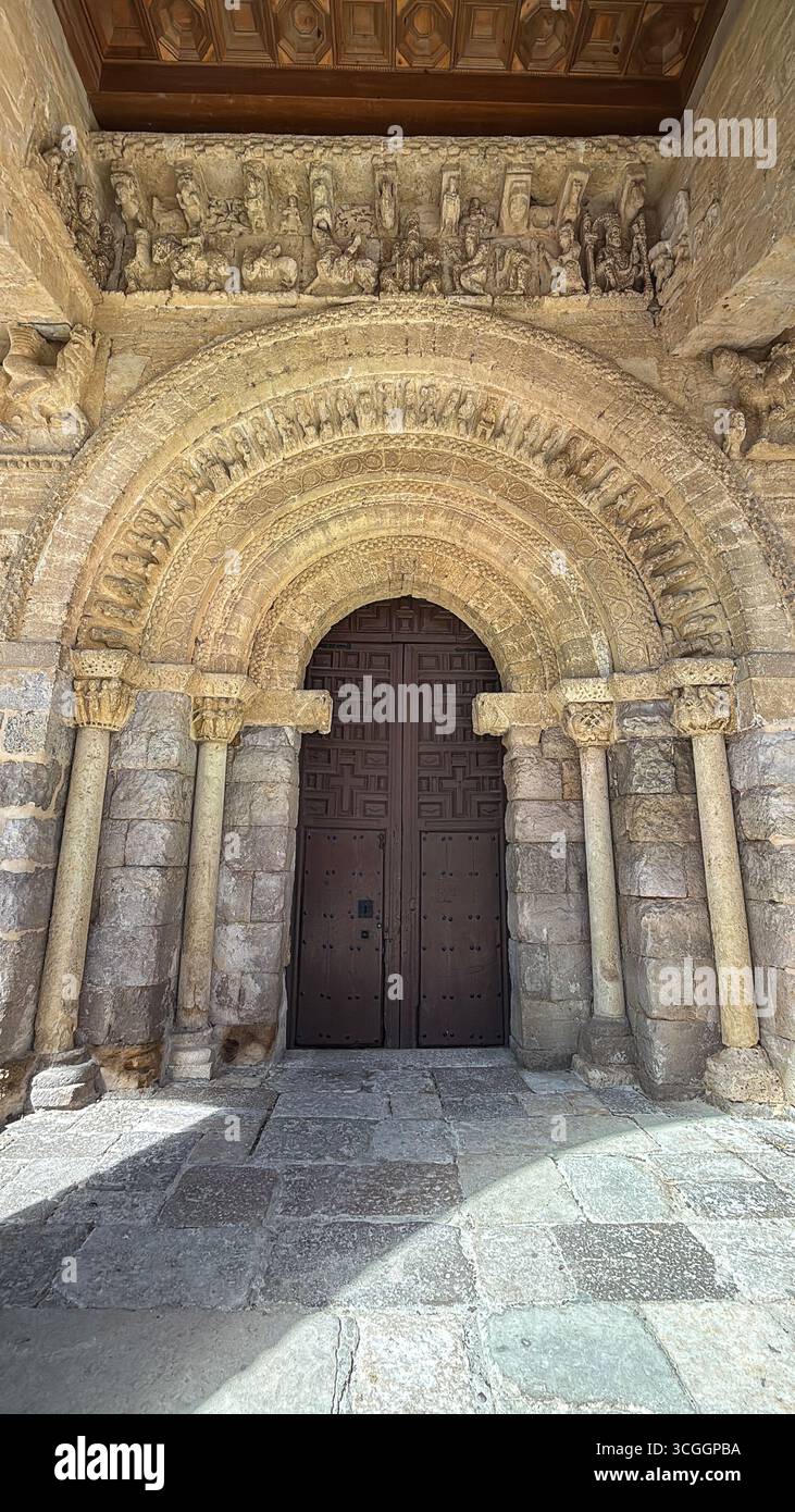 Intricate Romanesque sculptures above the entrance arch of a historic ...
