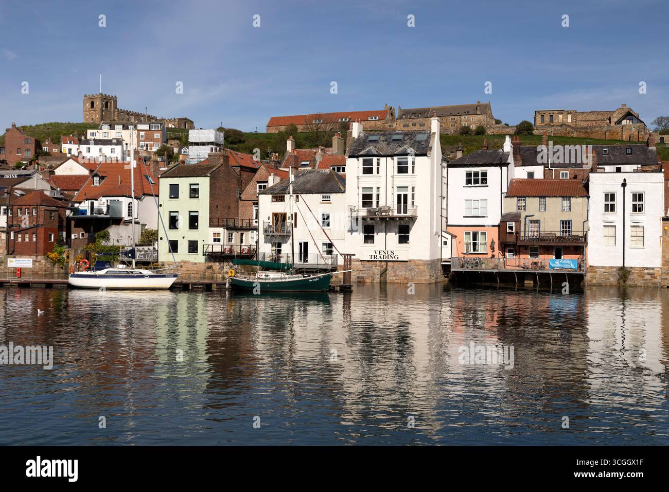 Buildings by the River Esk in Whitby, North Yorkshire, England. St Mary ...